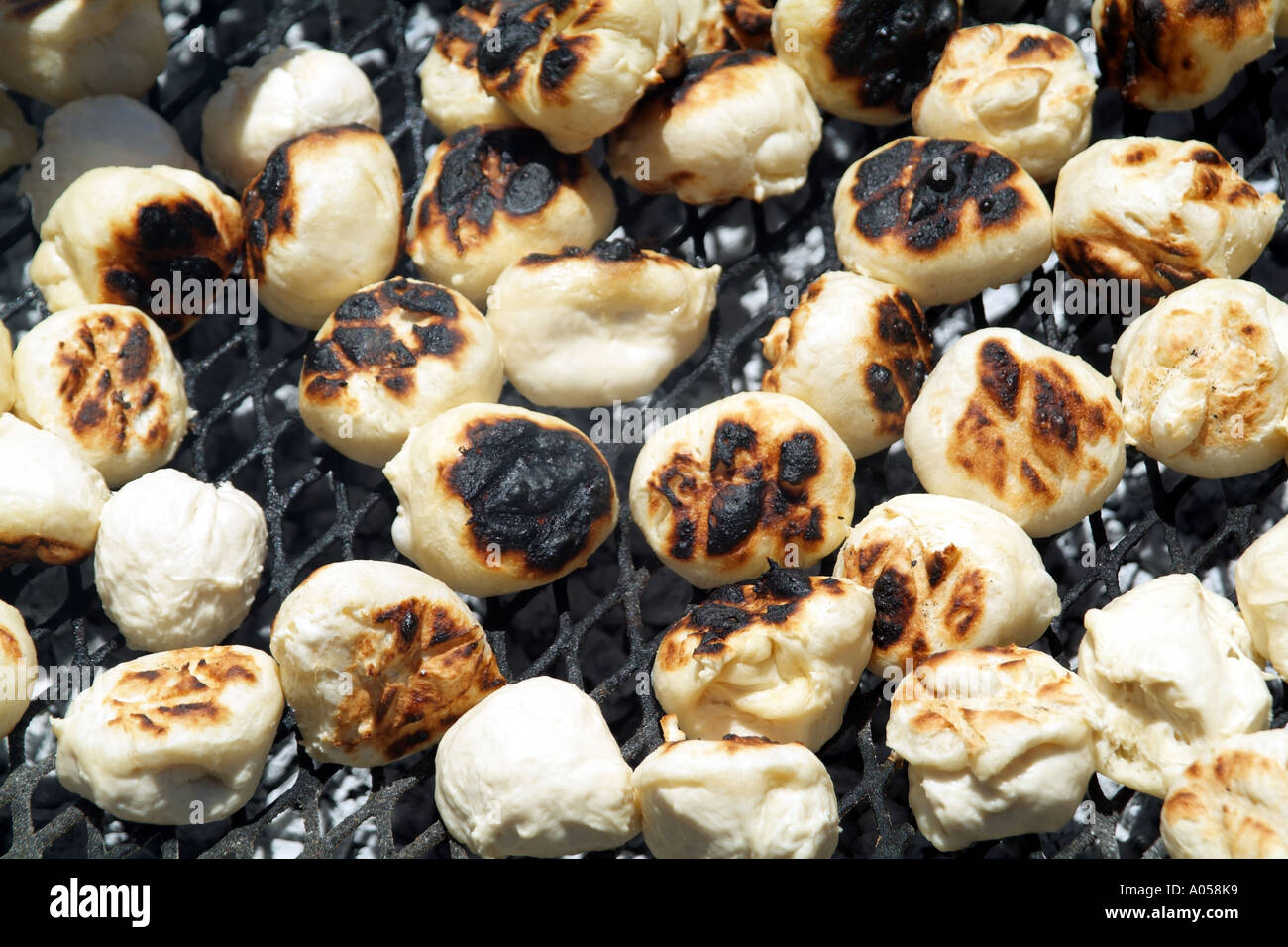 Bread rolls being baked on open fire Beach restaurant at Langebaan ...