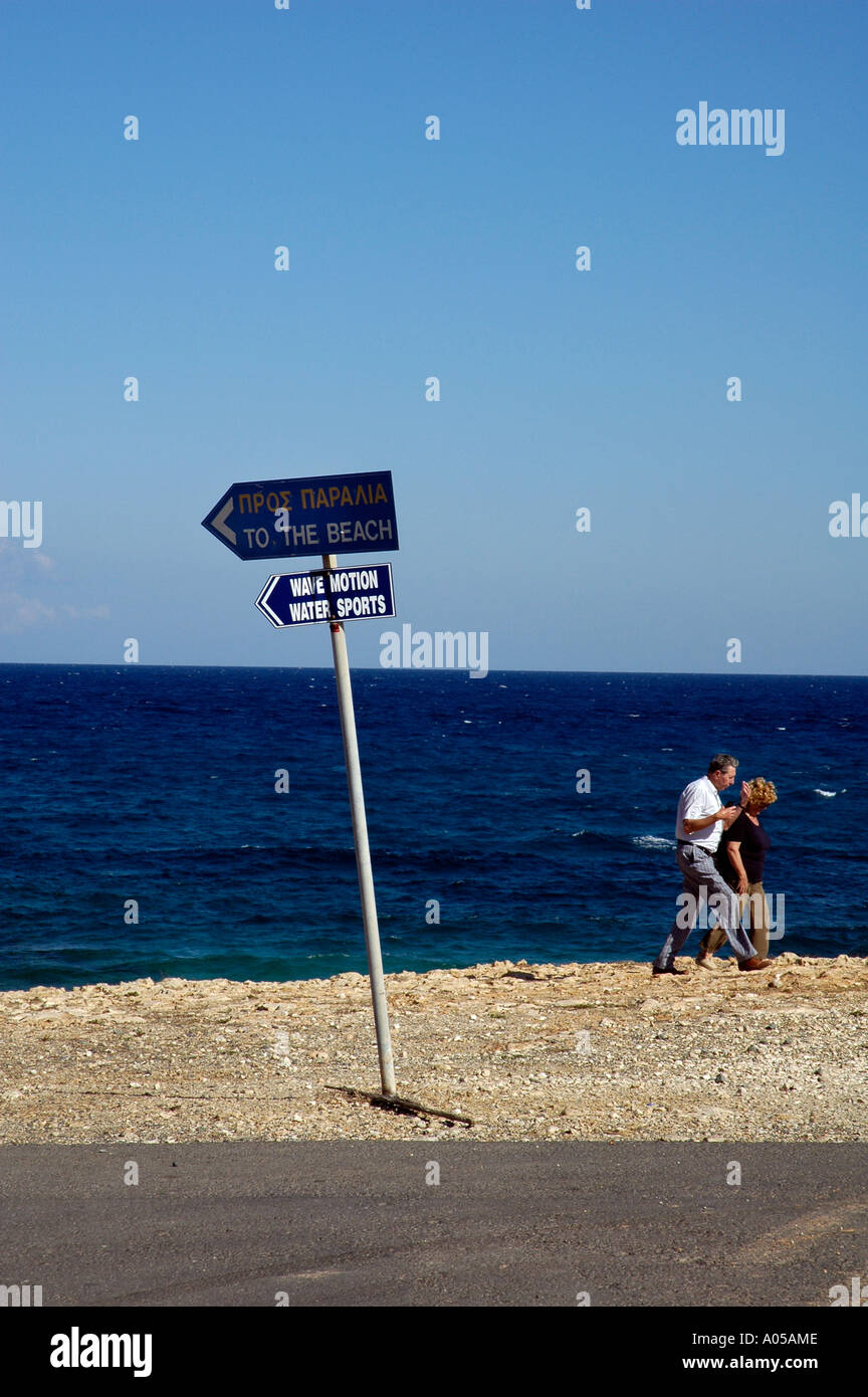 Direction to the beach sign at Green bay, Protaras, Cyprus with couple ...