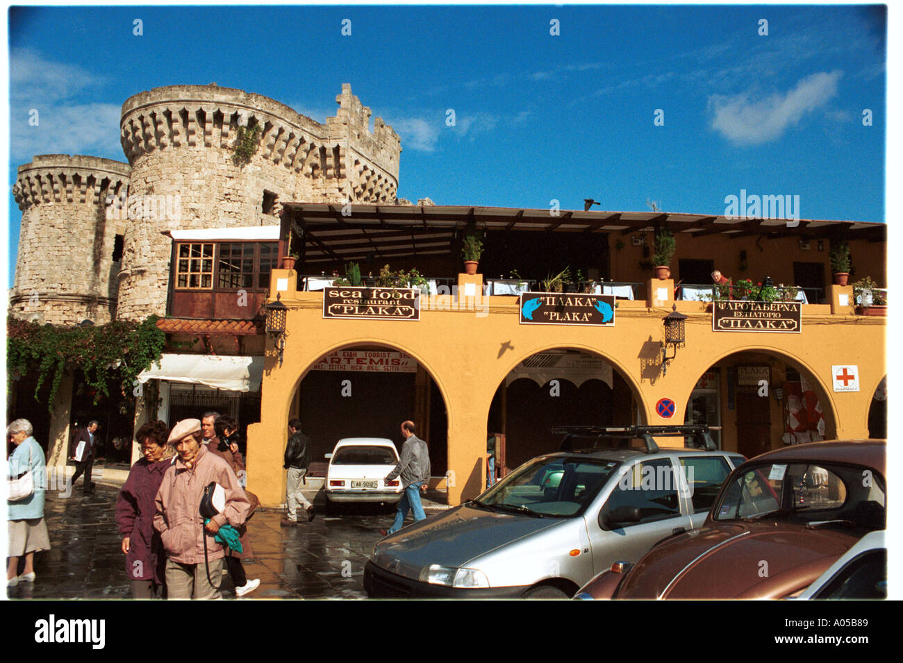 A modern restaurant with ancient ruins in the background Rhodes Greece ...