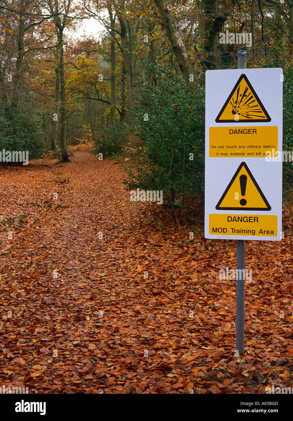Danger sign on woodland footpath through Ministry of Defence training ...