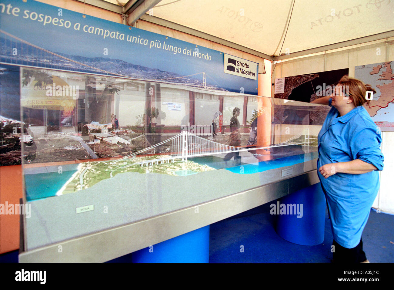 Woman cleaning the perspex cover of the Messina Bridge model Palermo ...