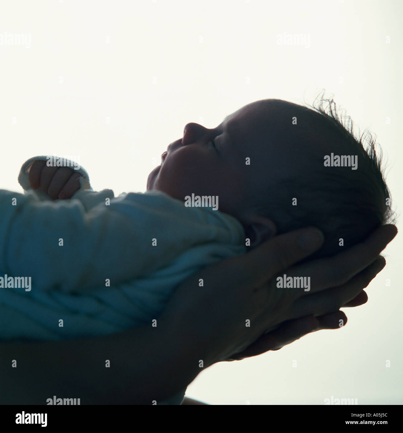 Held in his arms hi-res stock photography and images - Alamy