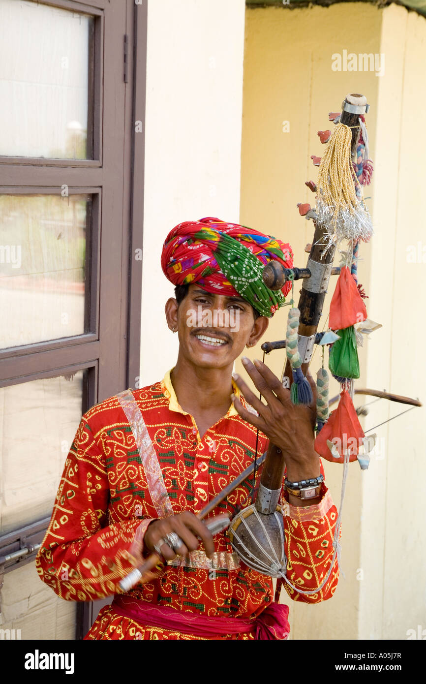 Young man in traditional costume playing old fashioned guitar ...