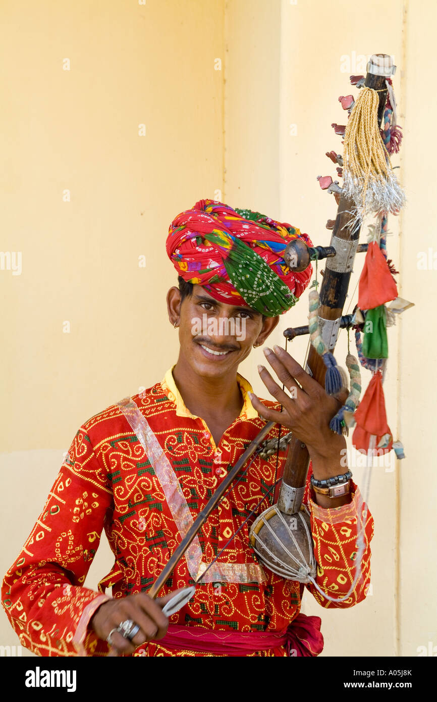 Young man in traditional costume playing old fashioned guitar ...