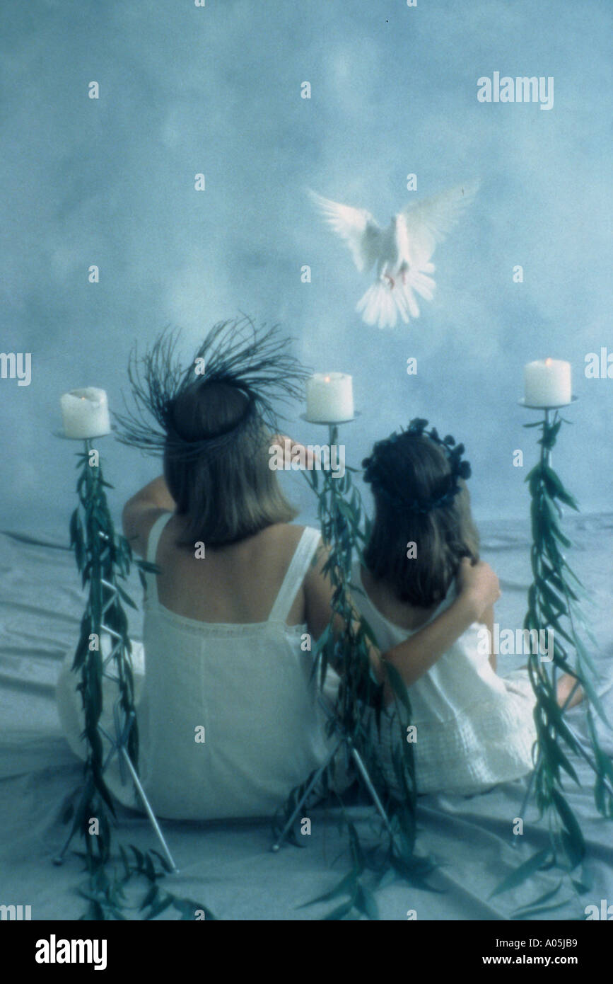Posterior view of two girls practicing some kind of Pagan ritual with a ...
