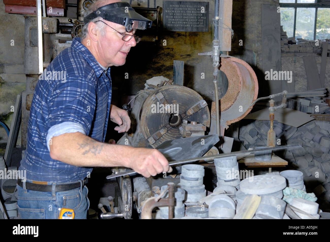 Craftsman Turning a Piece of Slate on Lathe Inside Workshop Inigo Jones ...