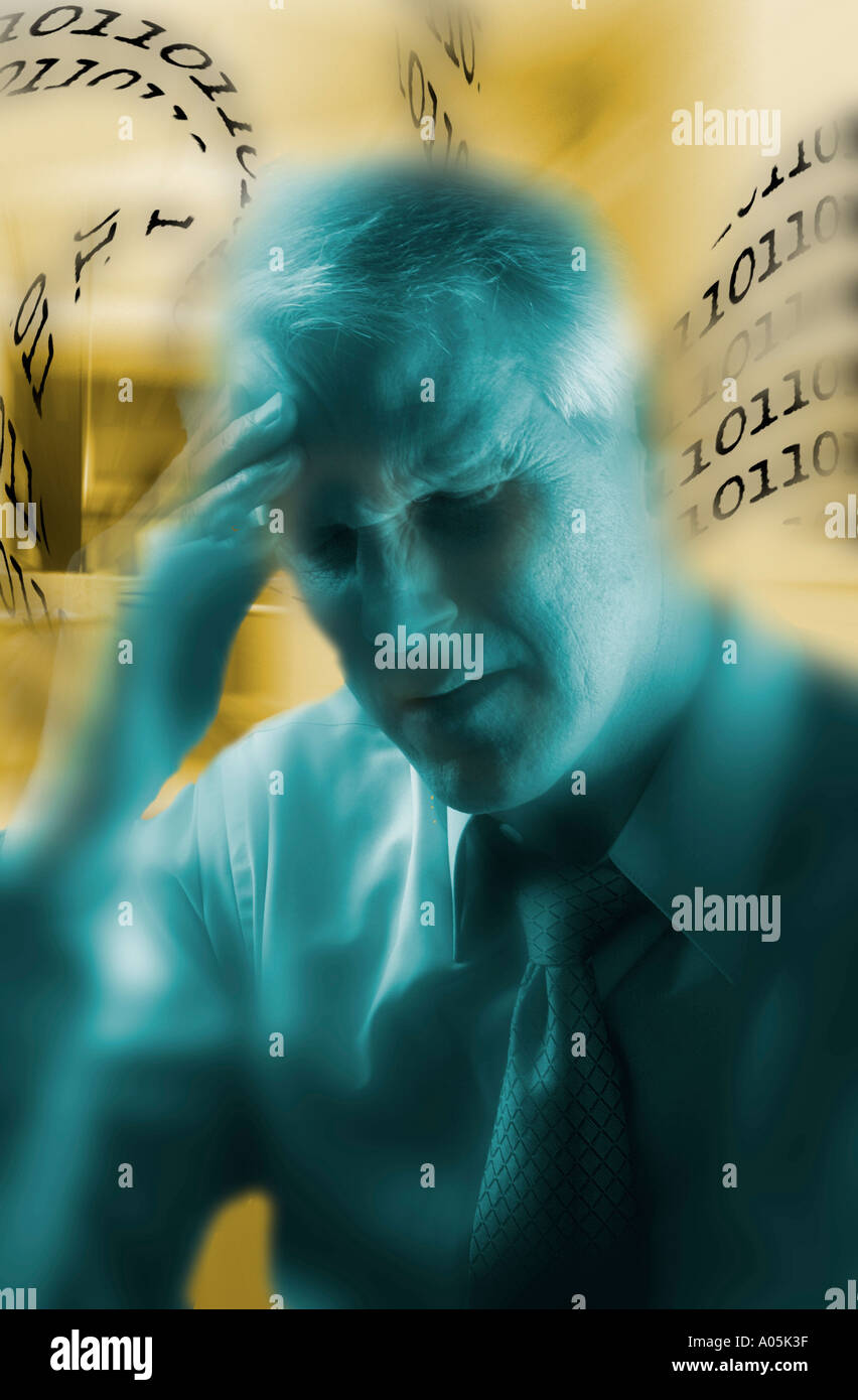 A business man with a pained expression holding his hand to his head ...