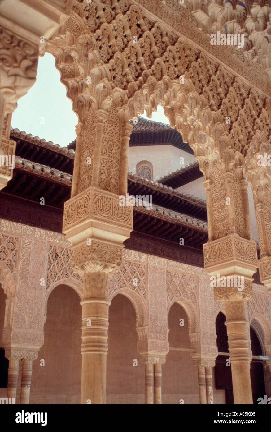 Looking through an ornate arch located at the Alhambra Palace of the ...