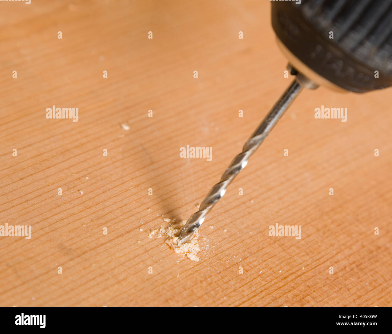 Drill bit making a hole Stock Photo - Alamy