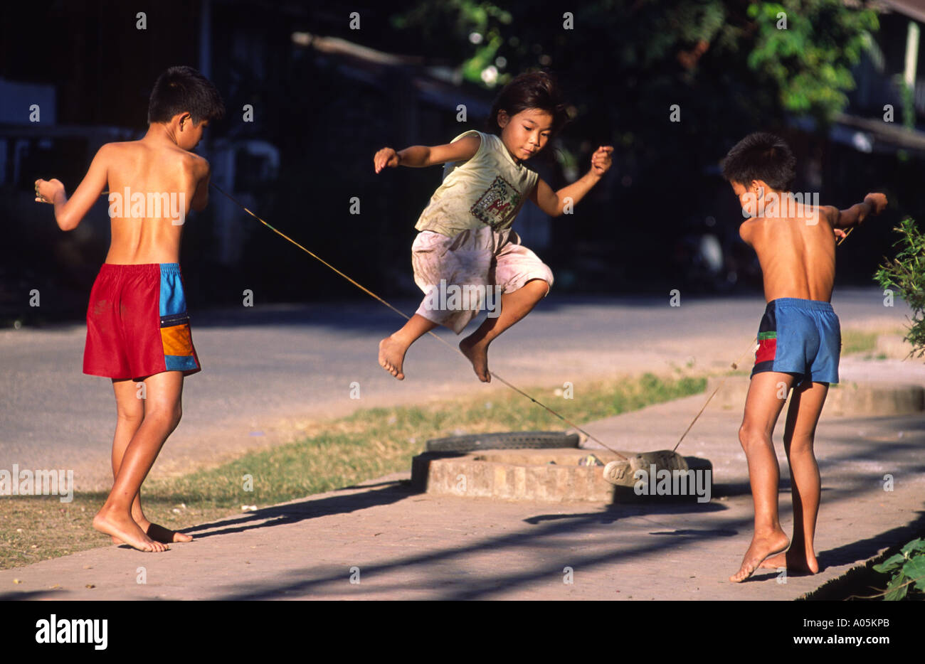 Lao kids jumping ropes. Luang Prabang, Laos Stock Photo - Alamy