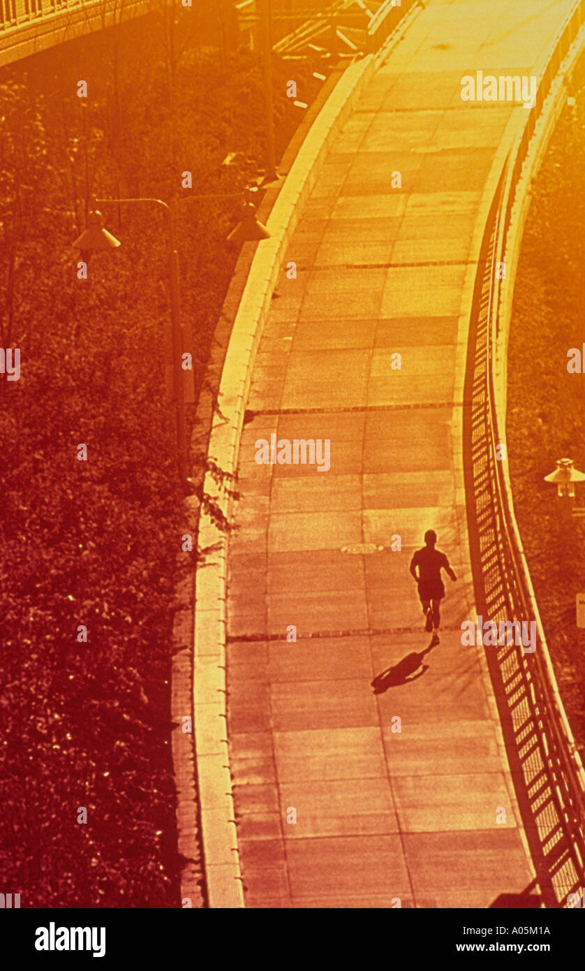 Overhead view of a man running for distance on a boardwalk Stock Photo ...