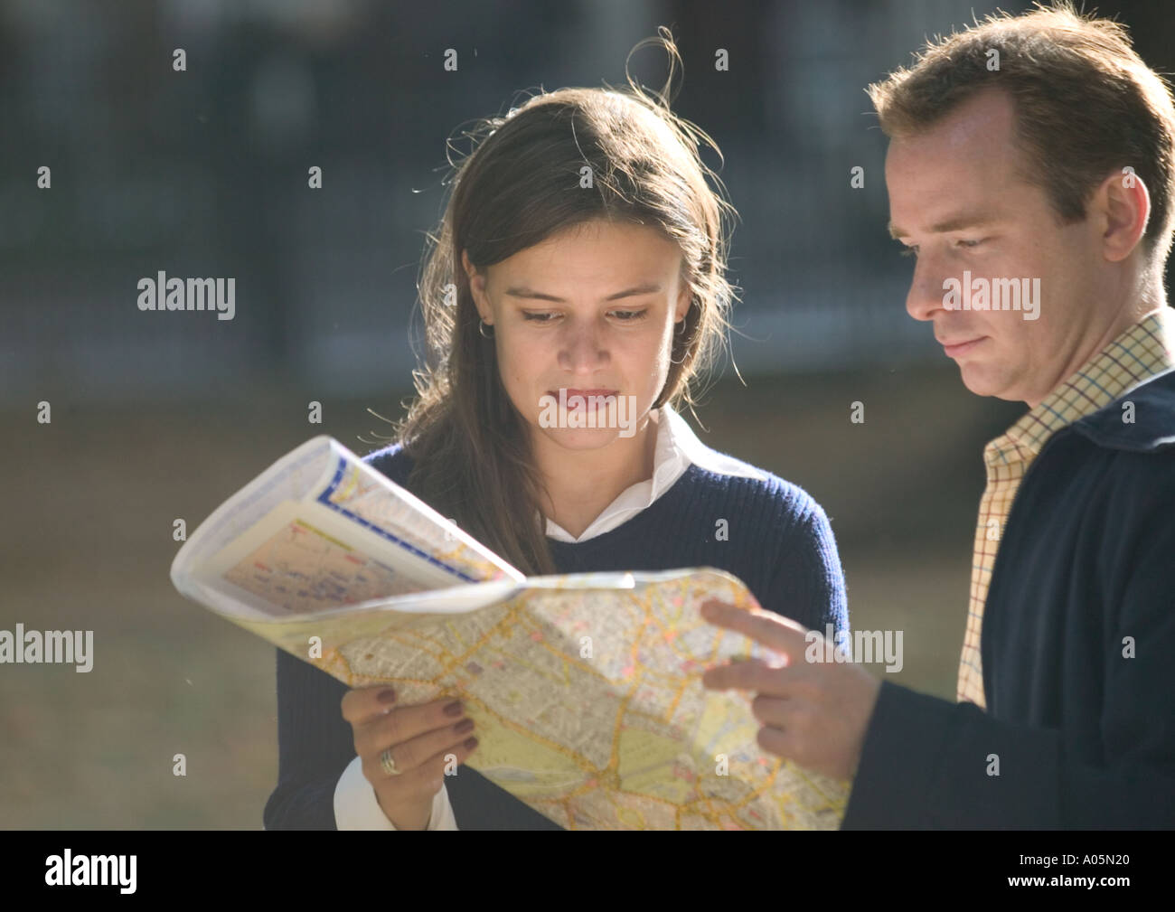 boy and girl looking at map for directions Stock Photo - Alamy
