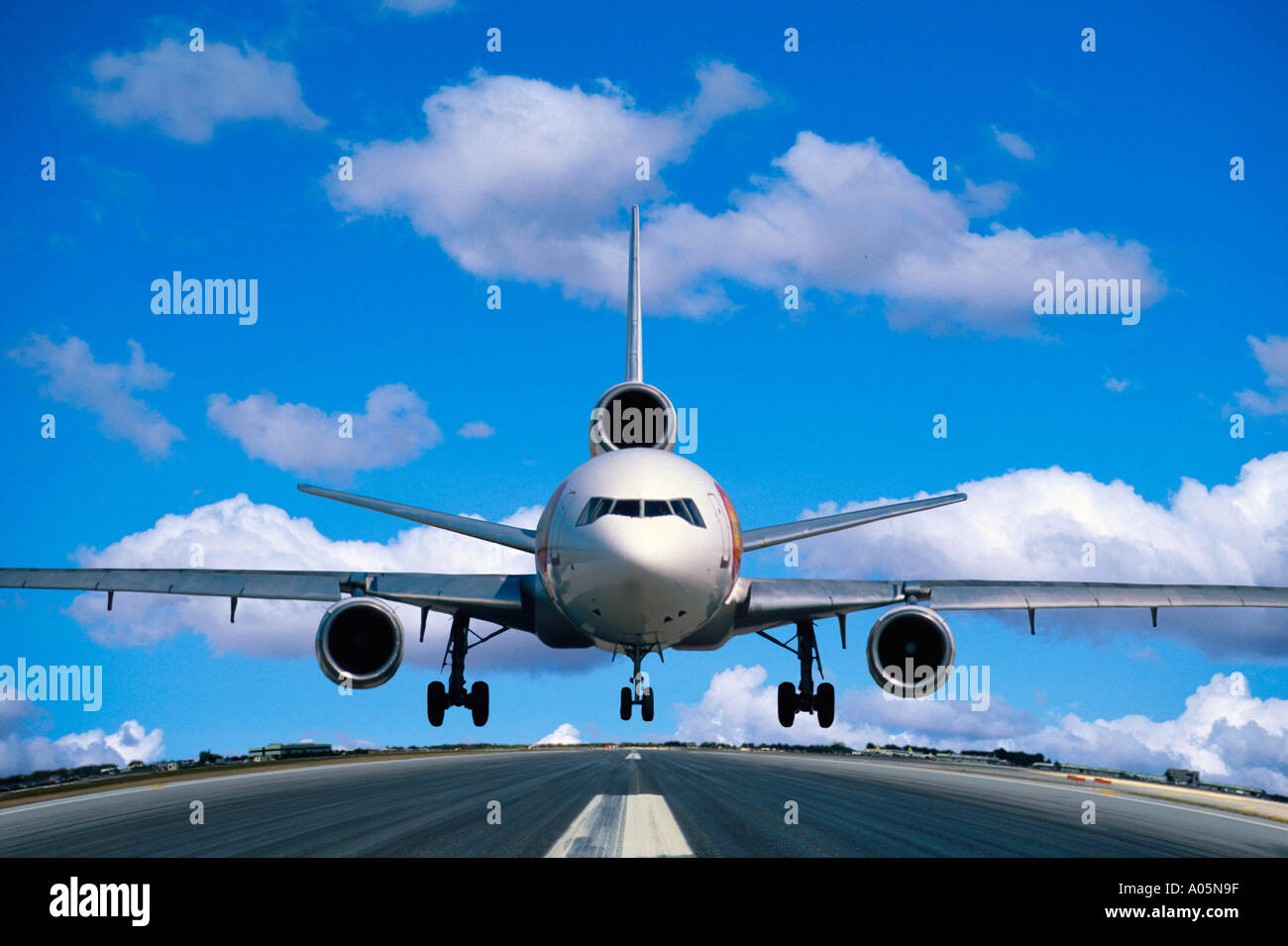 DC 10 jet airplane taking off as seen from the end of the runway Stock ...