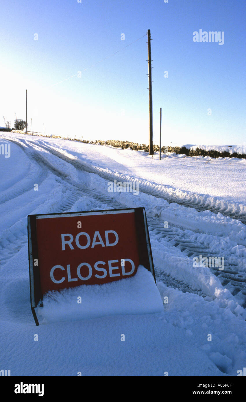 road closed sign on road blocked by deep winter snow at yeadon leeds ...