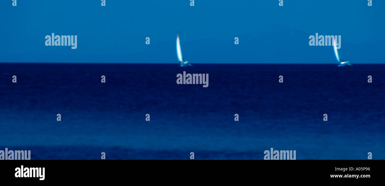 two small yachts sailing together over the horizon Stock Photo - Alamy