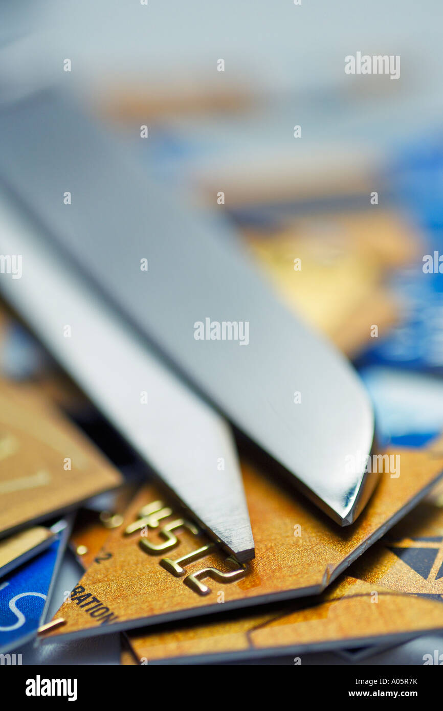 scissors on top of cut up credit cards Stock Photo - Alamy
