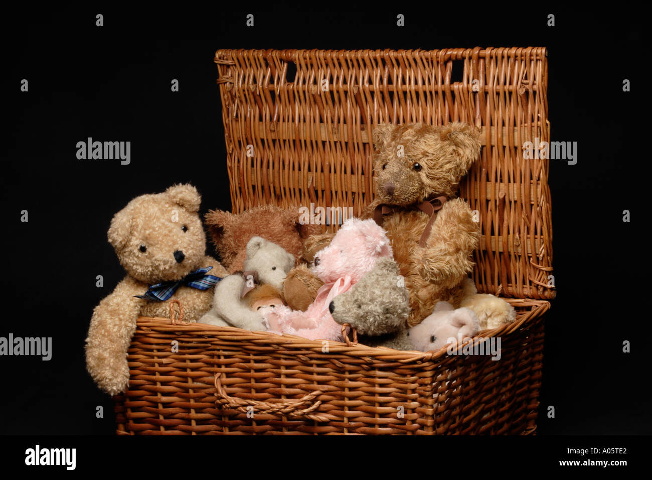 Childhood toys basket full of teddy bears Stock Photo - Alamy