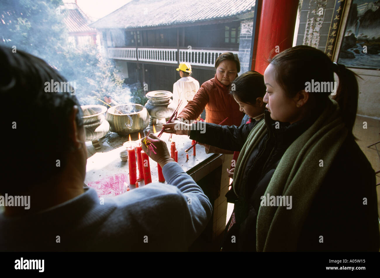 Lighting incense sticks candles temple hi-res stock photography and ...