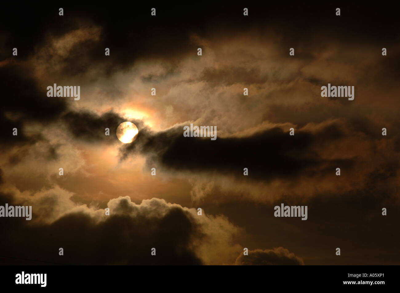 The Sun Appearing From Behind Clouds Stock Photo - Alamy