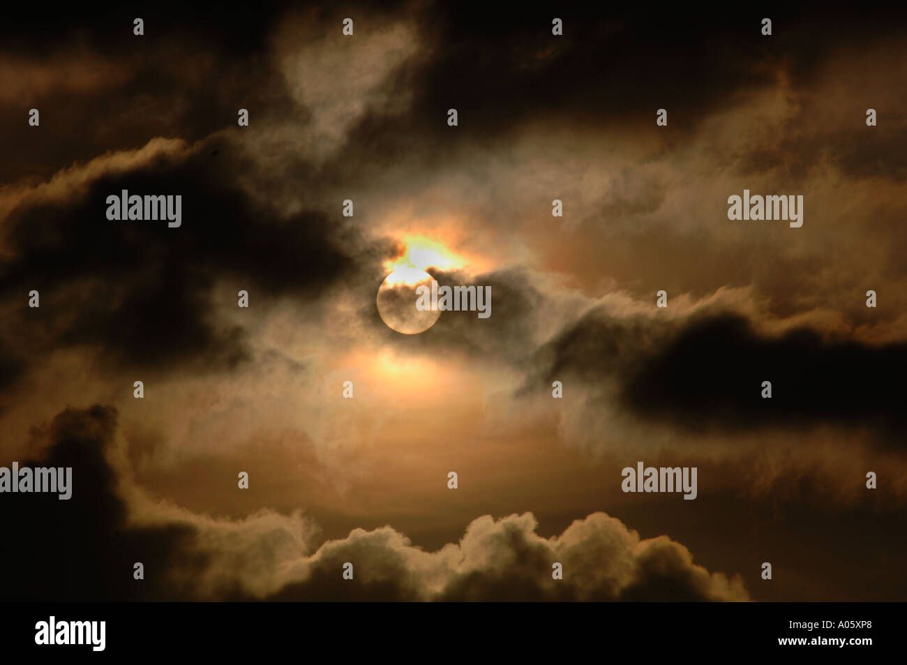 The Sun Appearing From Behind Clouds Stock Photo - Alamy