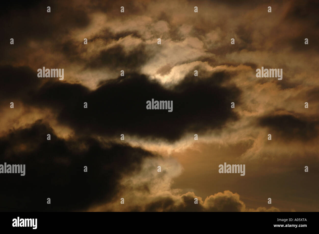 The Sun Backlighting Clouds In An Evening Sky Stock Photo - Alamy
