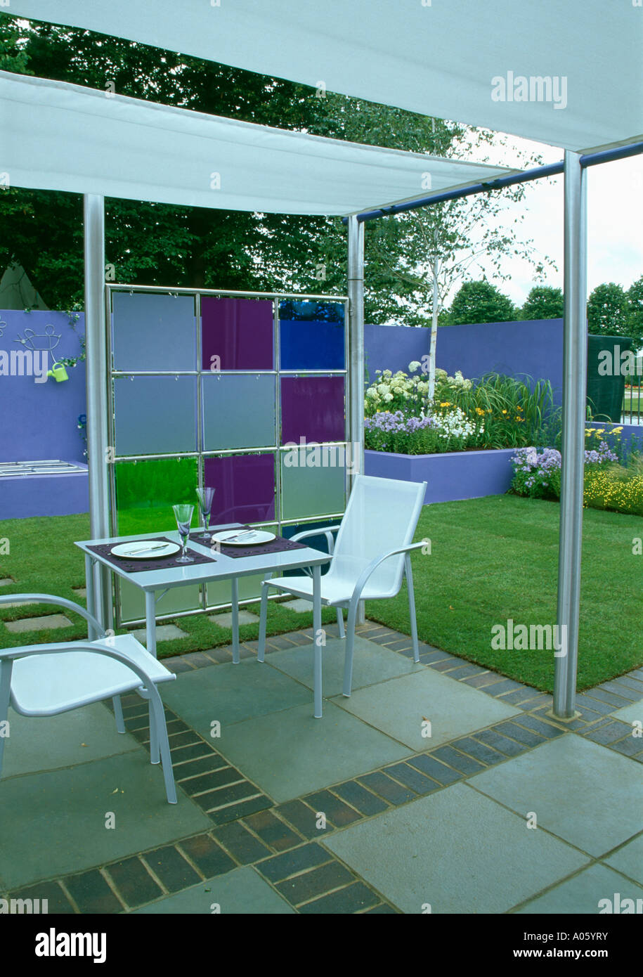 Modern garden furniture on patio in architectural gazebo with blue and ...