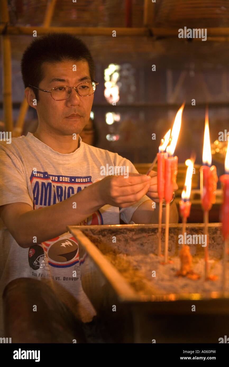 Local Chinese man praying in the Man Mo temple in Hong Kong Stock Photo ...