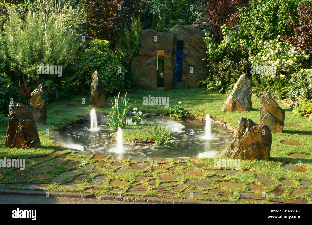 Monolith rock sculpture around circular pool with fountains Stock Photo ...