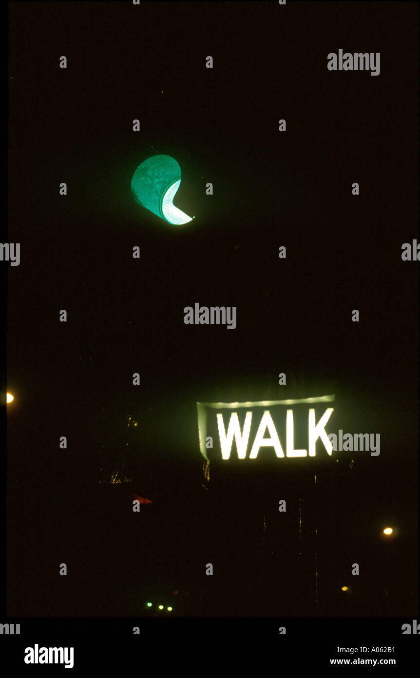 Green traffic signal walk sign at night Stock Photo - Alamy