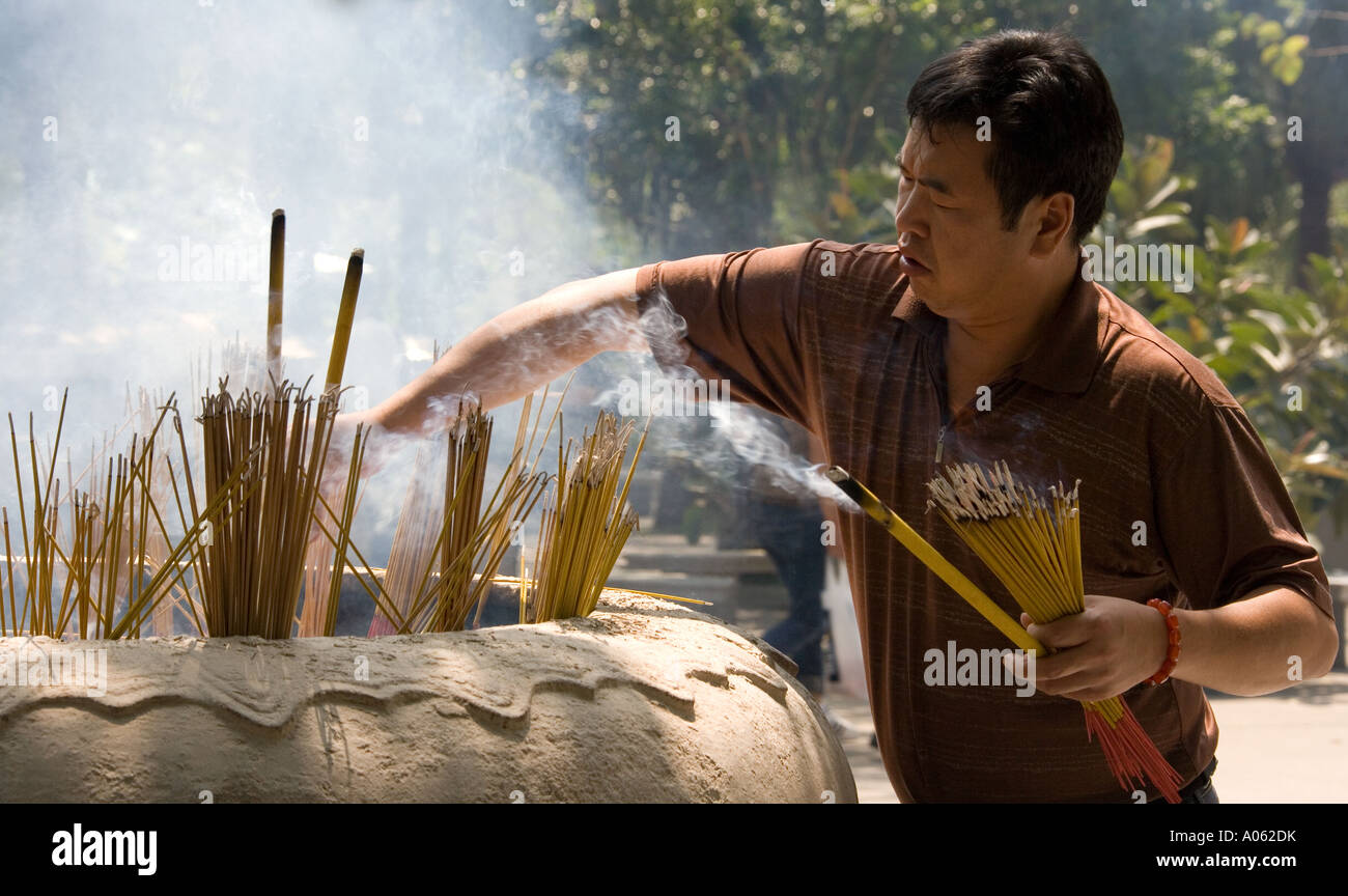 Local Chinese man praying at the Po Lin Monastery on the island of ...