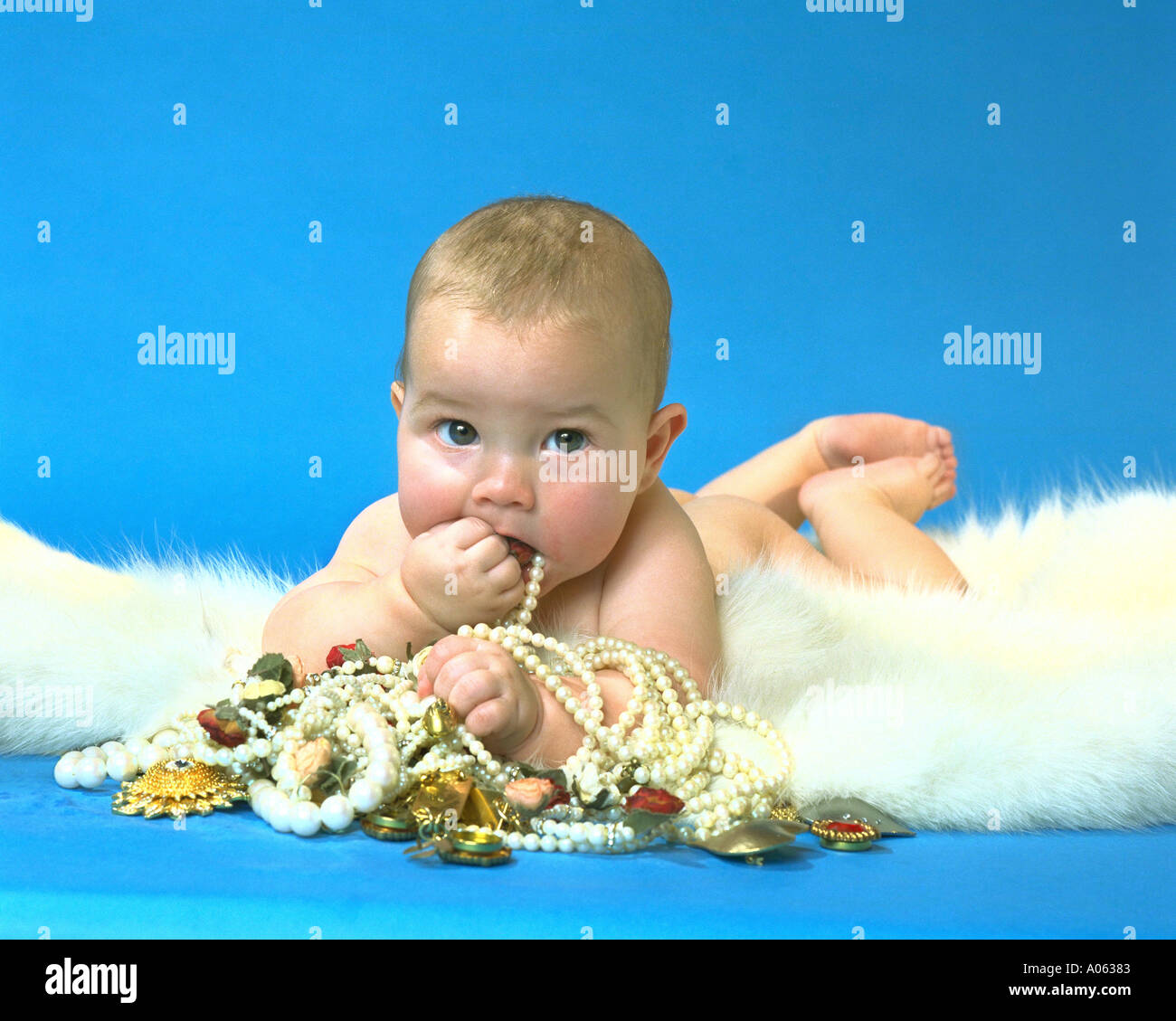 baby child en face belly situation on mink fur with gold ornaments ...