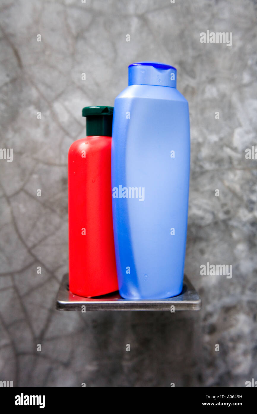 Shampoo and conditioner on a small bathroom shelf in a modern wet room ...