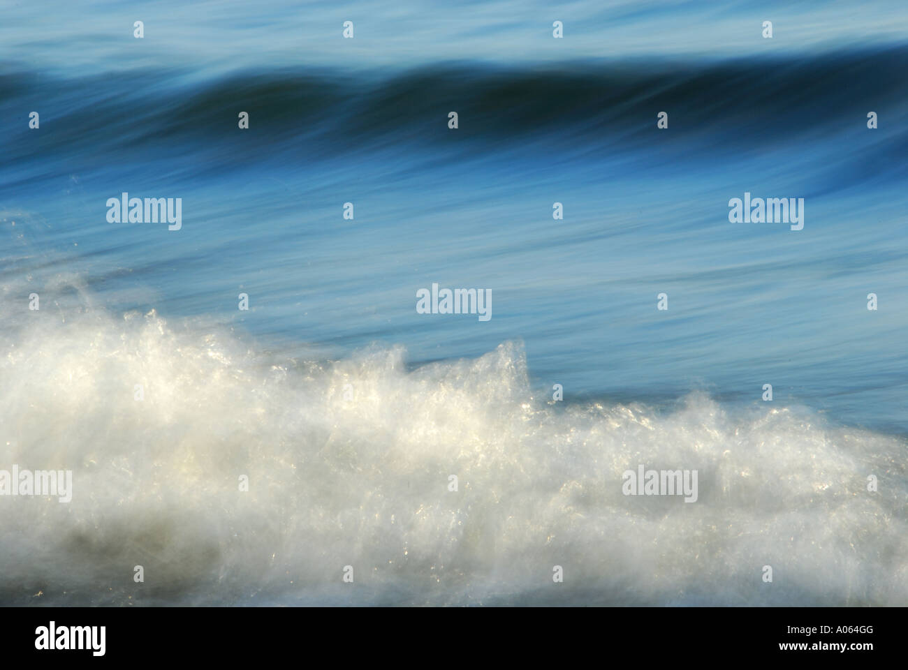 blue ocean wave crashing onto beach Stock Photo - Alamy