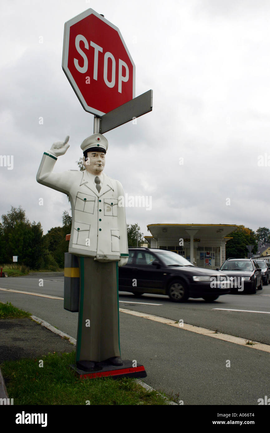 An effigy of a traffic cop showing the STOP signal is seen beside the ...