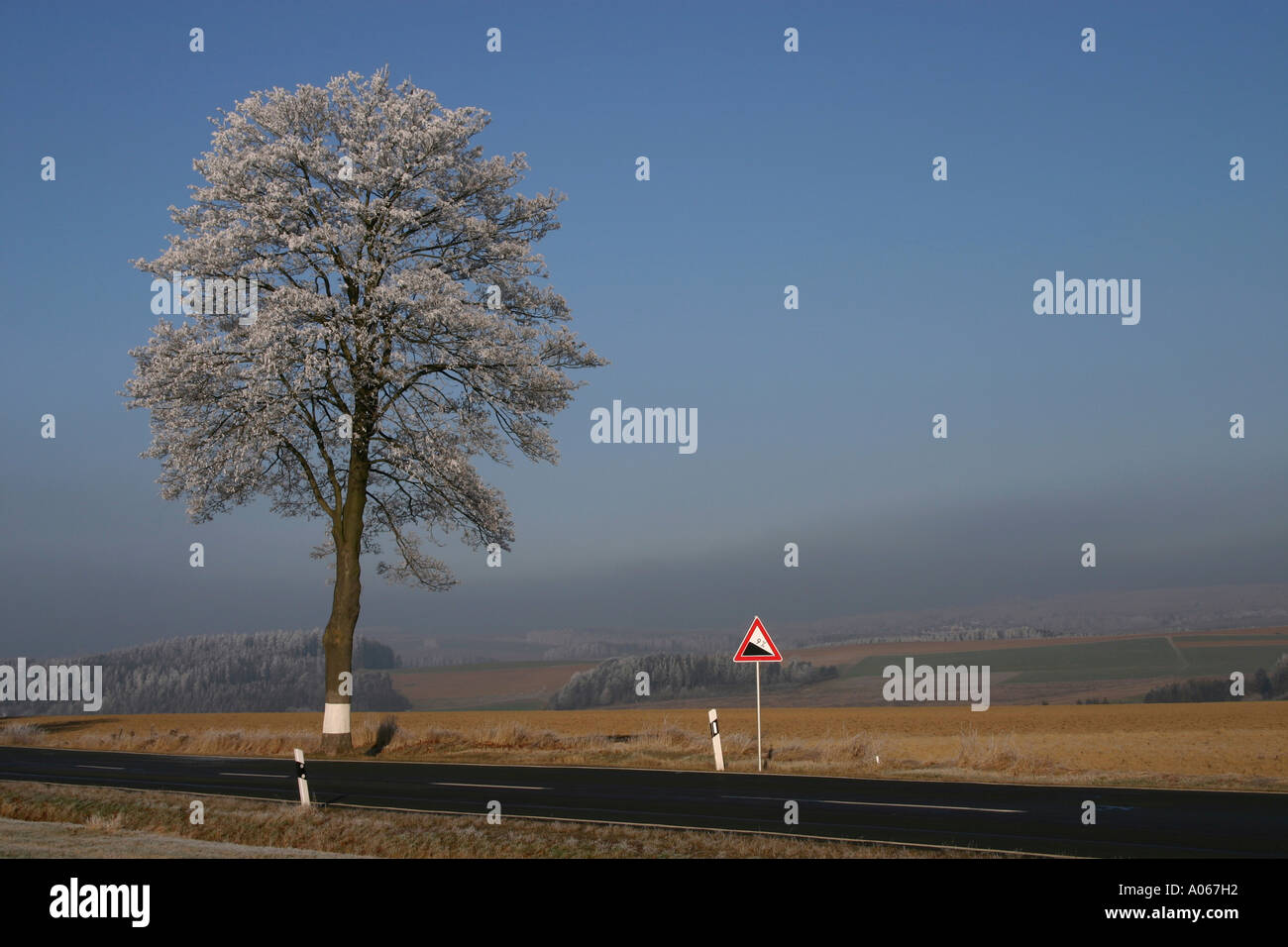 A triangular signboard is seen beside the highway Stock Photo - Alamy