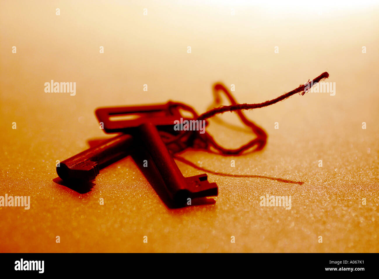Close up of two keys tied with thread kept on a chilled surface Stock ...
