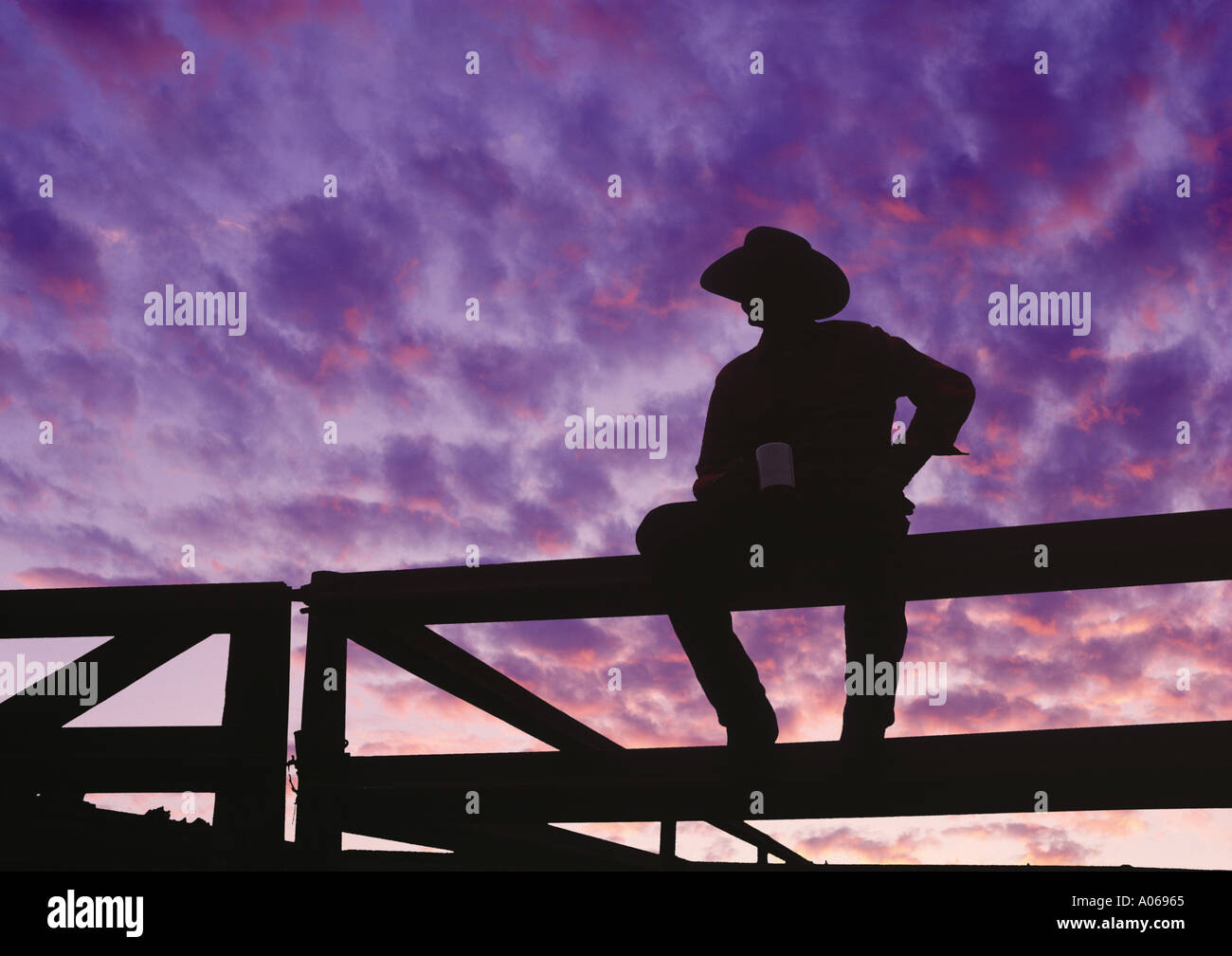 USA silhouette of western rodeo Cowboy sitting on fence Stock Photo - Alamy