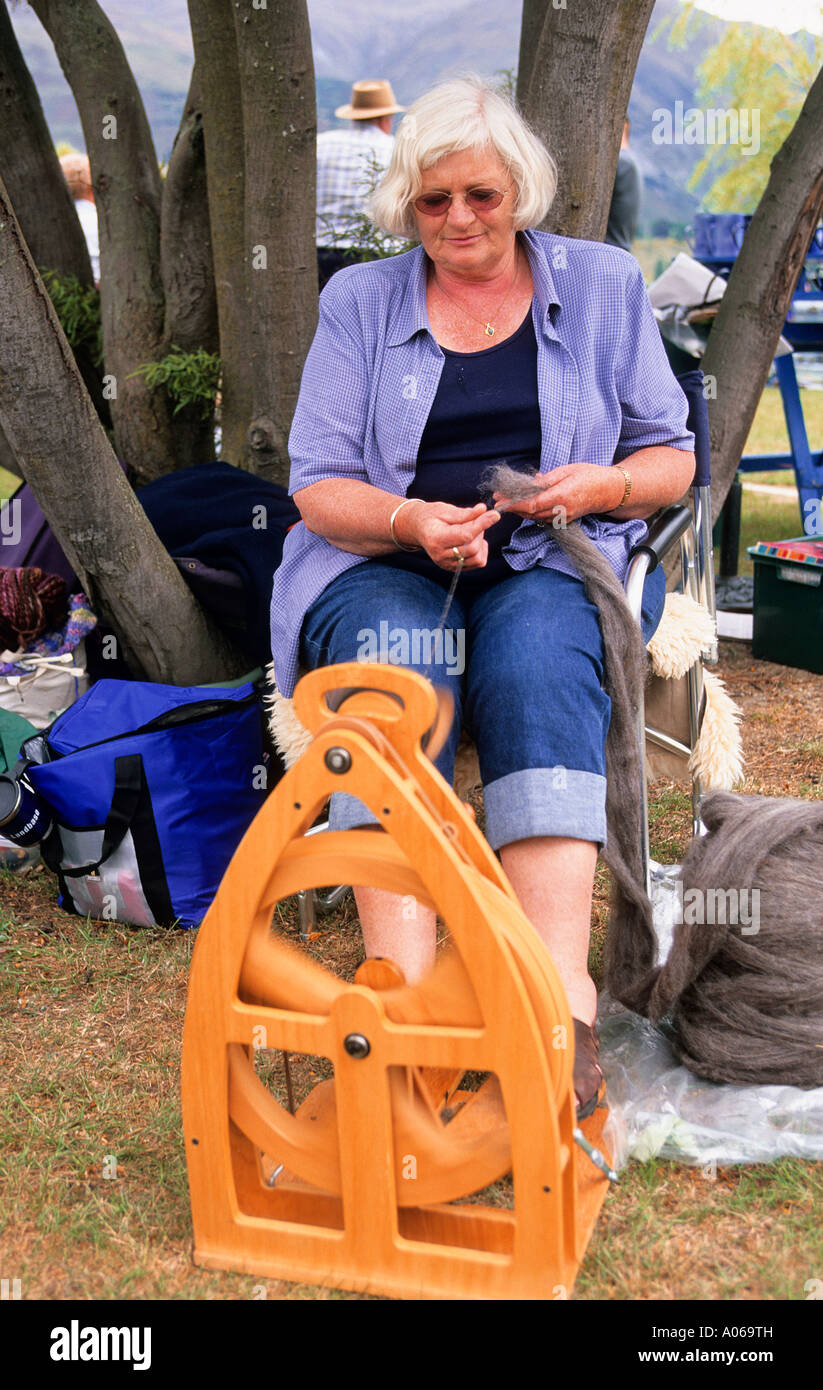 A woman sat spinning wool at a craft fair Wanaka Stock Photo - Alamy