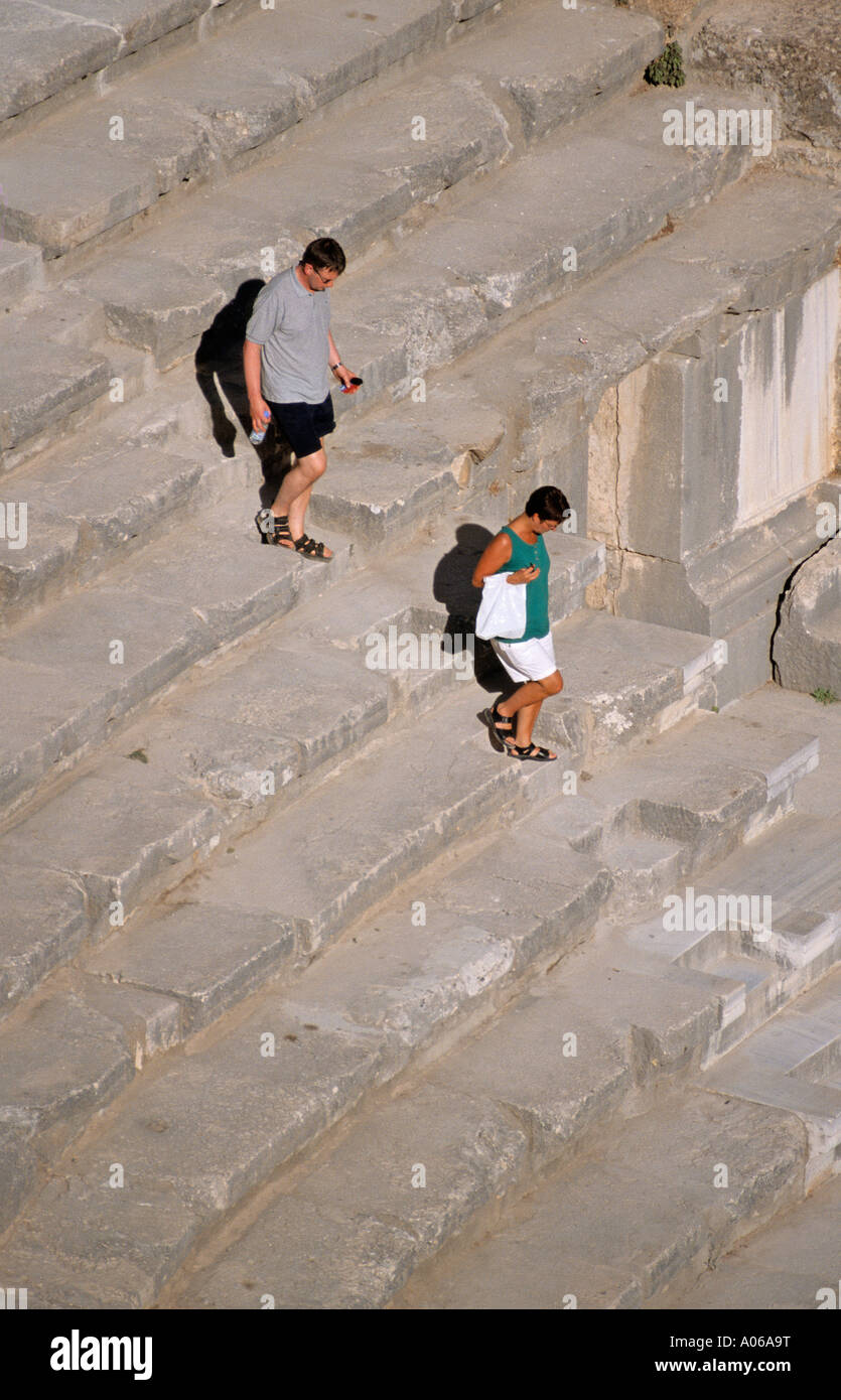 Tourist climbing down the stone steps of the ancient amphitheatre said ...