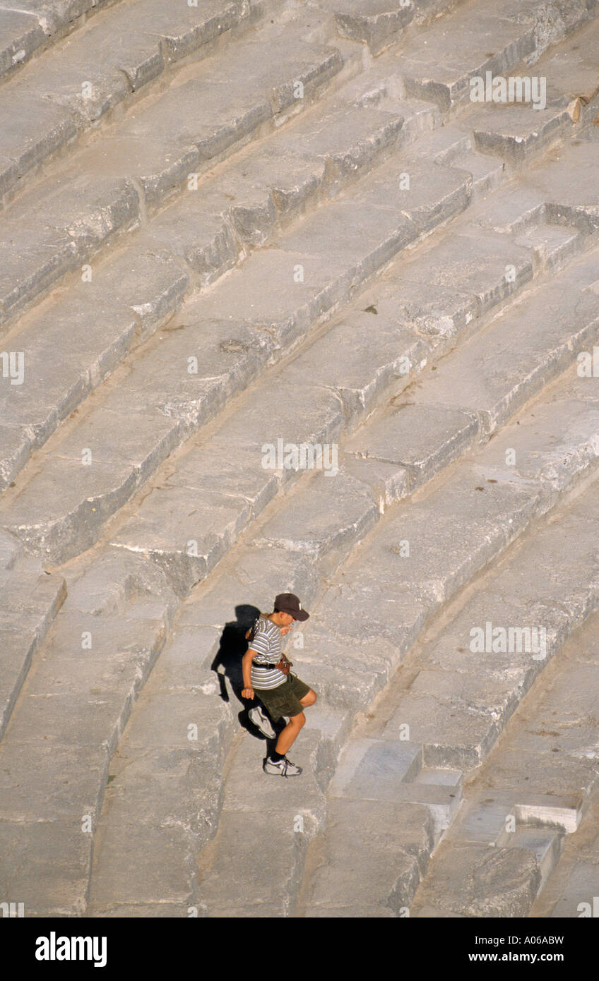 Tourist climbing down the stone steps of the ancient amphitheatre said ...