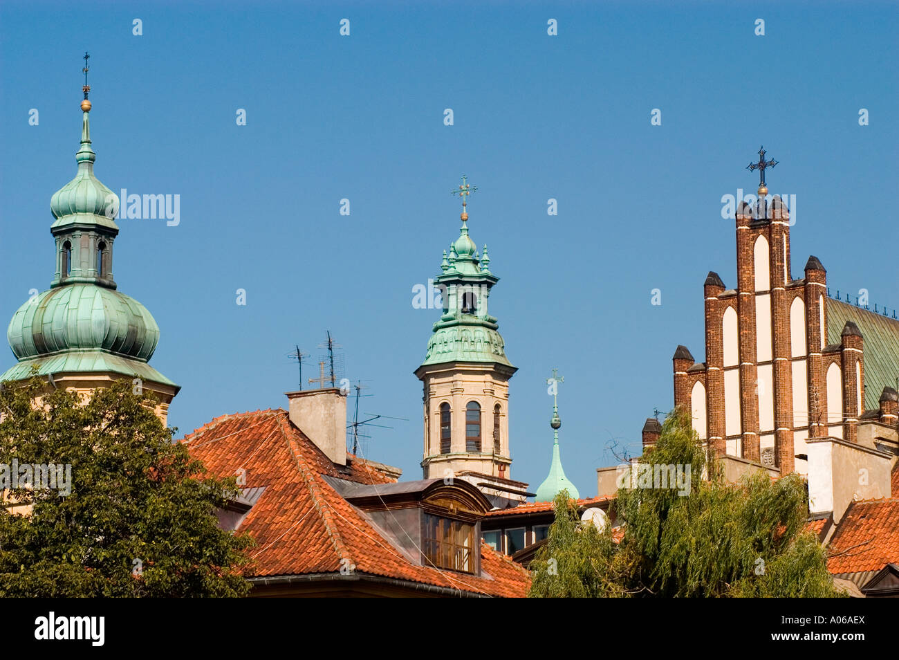 Spires and red rooftops of churches in UNESCO Old Town blue sky Warsaw ...