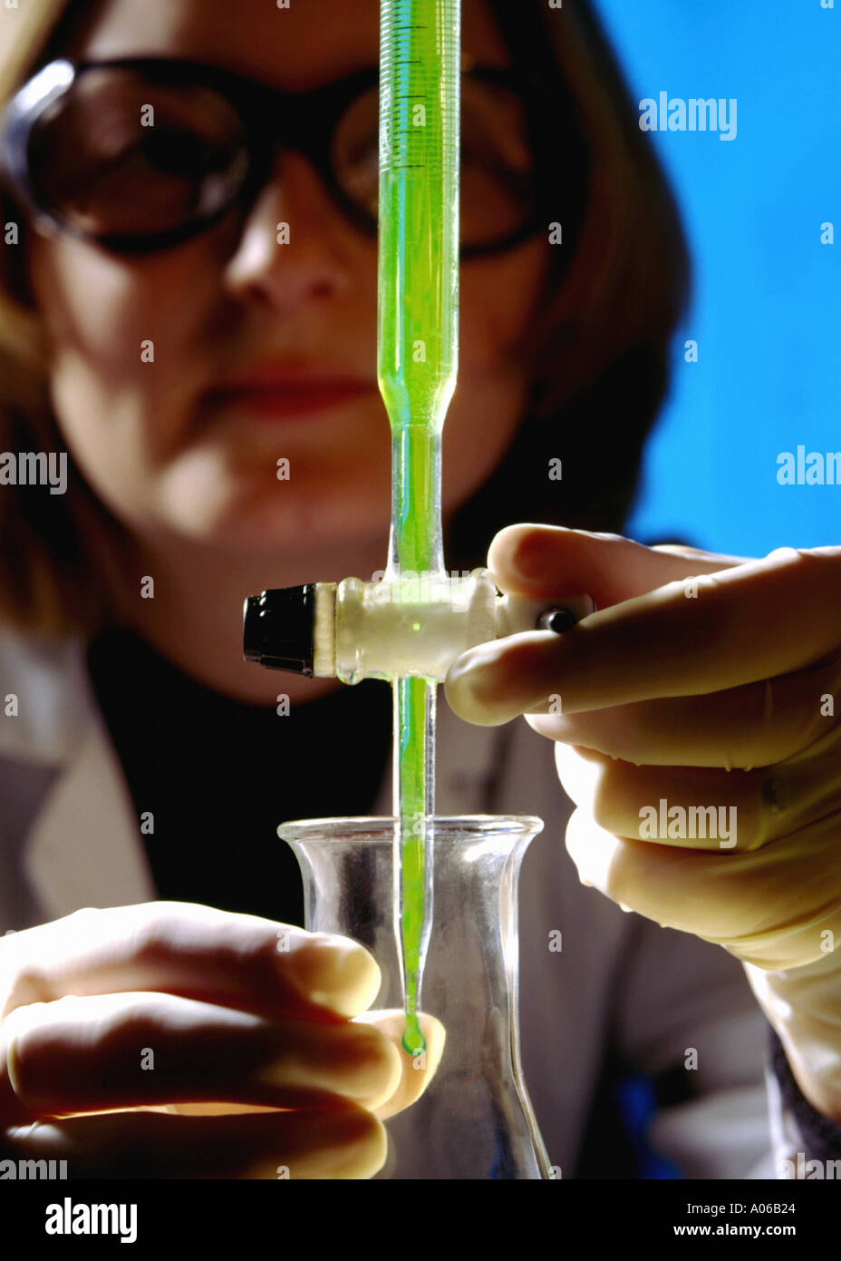 Laboratory technician pouring liquid into flask Stock Photo - Alamy