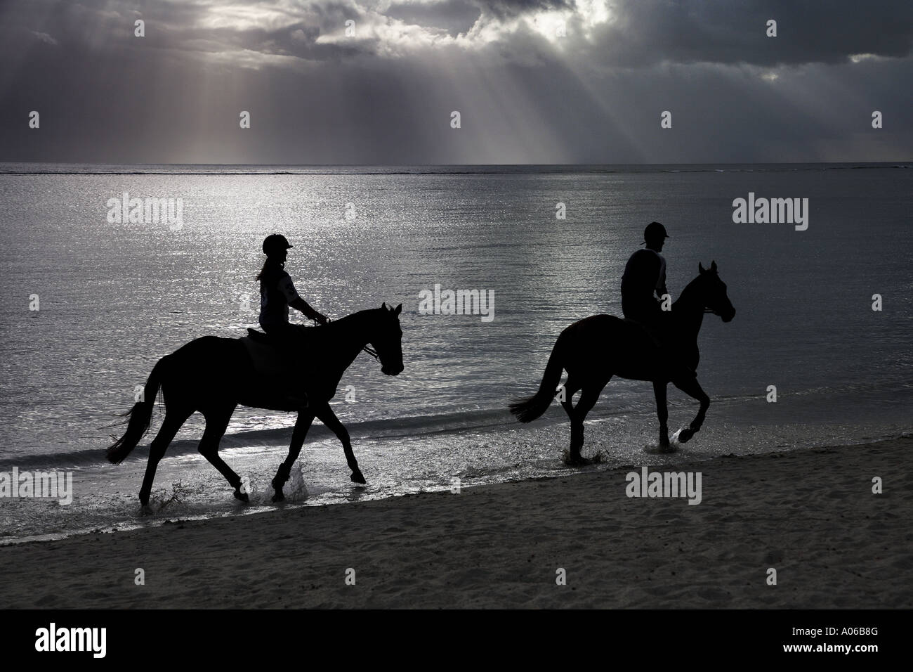 two horse riders on a beach Stock Photo - Alamy