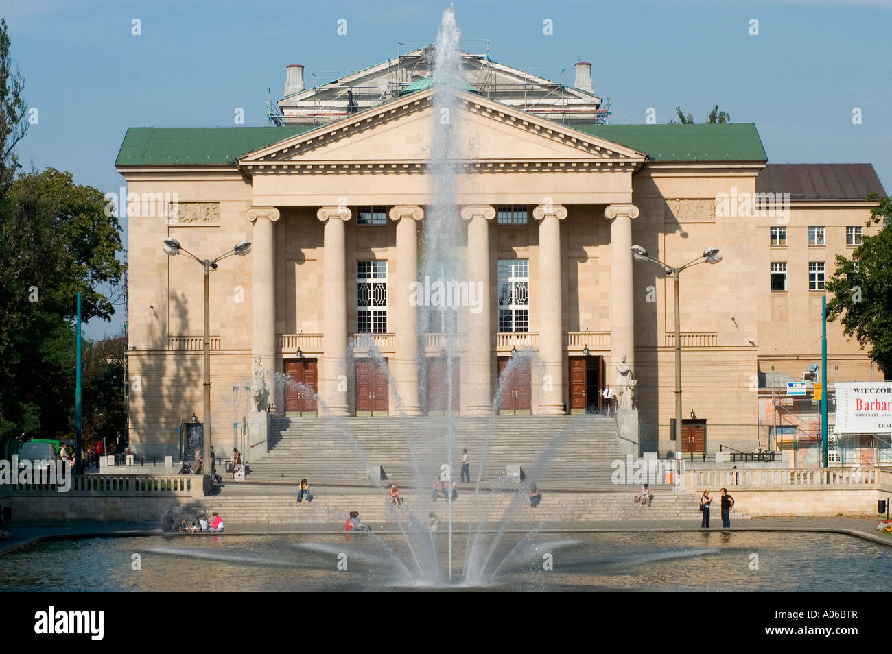 Poznan Great Theatre or Opera building with fountain and blue sky ...