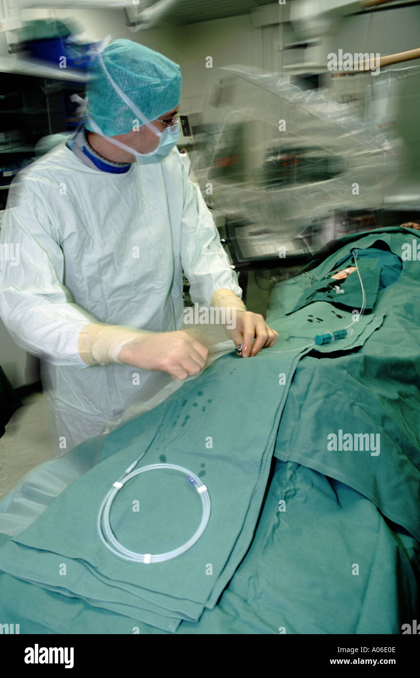 RADIOLOGIST PERFORMING CATHETERISATION OF THE AORTA THROUGH A FEMORAL ...