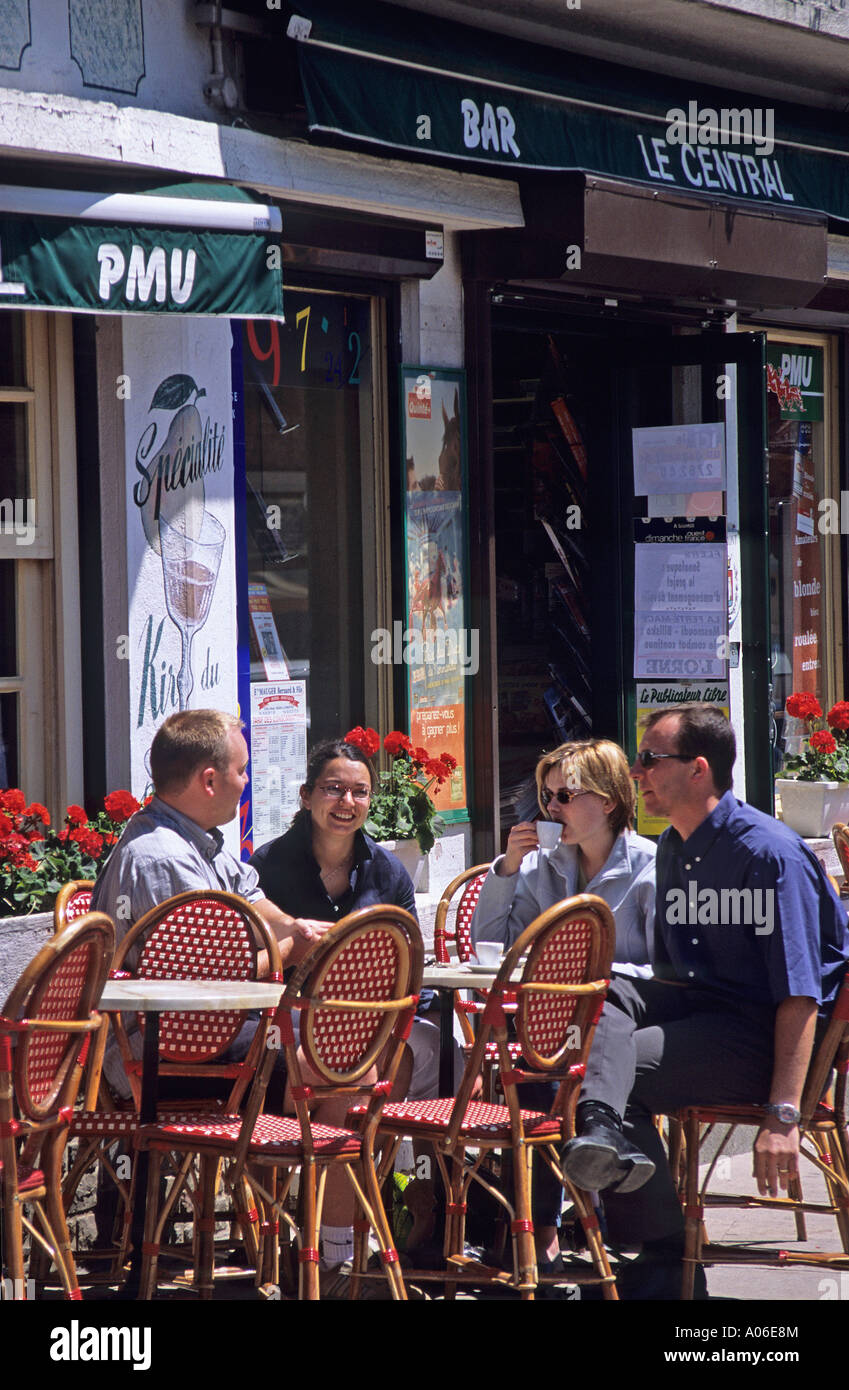People eating and drinking outside of a café in Domfront Stock Photo ...