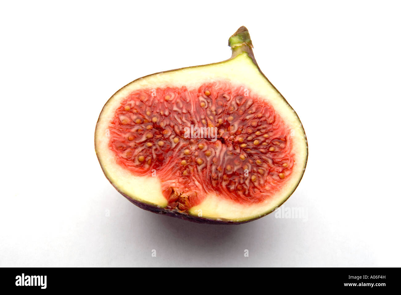 Halved fig isolated on a white studio background Stock Photo - Alamy