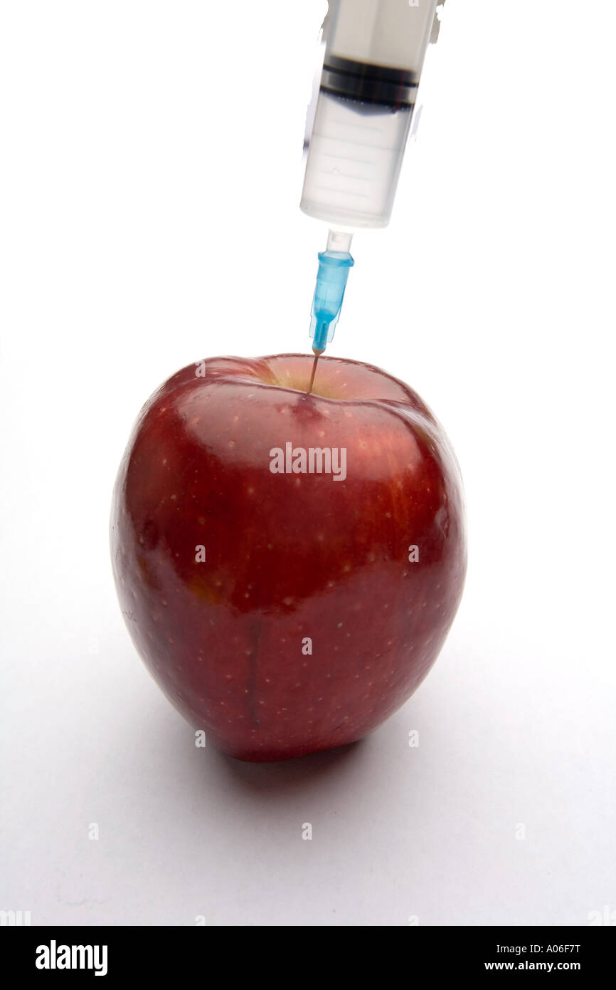 Apple being injected with a clear liquid Stock Photo - Alamy