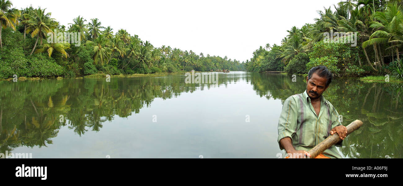 India Kerala backwater man rowing small boat panoramic Stock Photo - Alamy