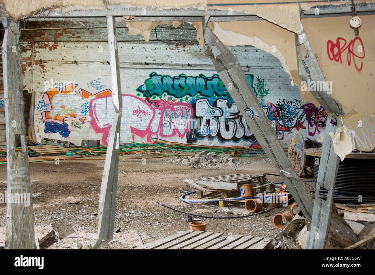 Mangled framework and thick bold graffiti spray painted on the walls of ...